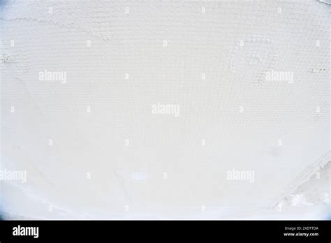 Builder Installing Rigid Styrofoam Insulation Board For Energy Saving
