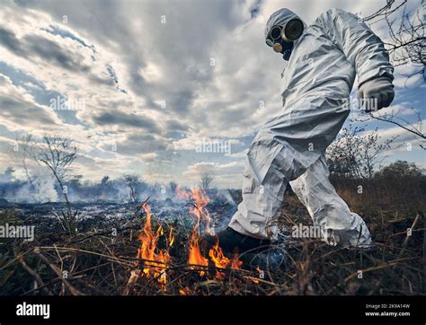 Firefighter Ecologist Fighting Fire In Field Man In Protective