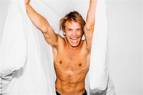Young Man Covering Himself With Sheet And Laughing By Stocksy
