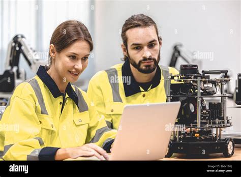 Electronics Engineer Team Works With Iot Robot Checking Source Code And