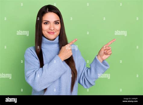 Photo Of Sweet Adorable Young Woman Wear Blue Sweater Smiling Pointing