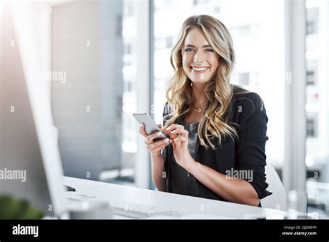 Productivity Driven By Technology Shot Of A Young Businesswoman Using A Mobile Phone At Her