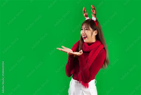 Young Pretty Asian Woman In Red Sweater And Scarf Wear Reindeer Horns
