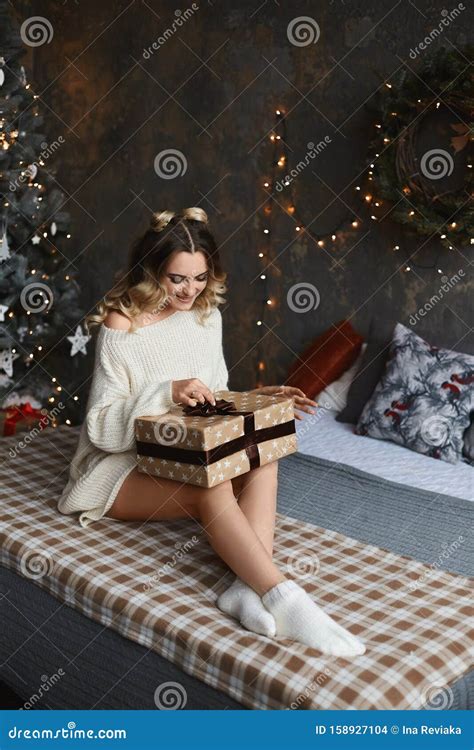 Beautiful And Young Model Woman With Legs In Oversize Sweater Sits On