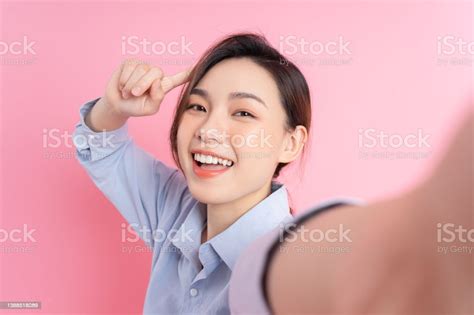 ピンクの背景にポーズをとっているアジアの若い女の子の肖像画 セルフィーのストックフォトや画像を多数ご用意 セルフィー 東アジア系民族