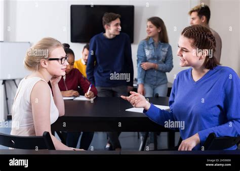Interested Classmates Having Animated Talks At Break Between Classes