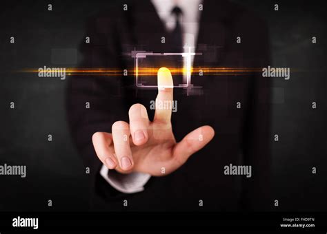 Tech Business Person Touching Button With Orange Light Beams Concept