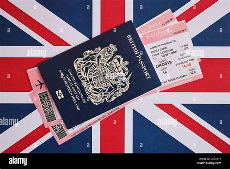 Blue British Passport With Airline Tickets On National Flag Background