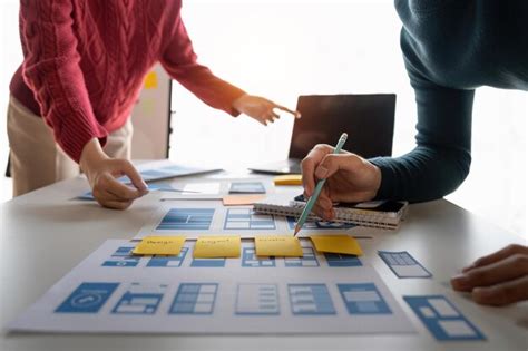 Premium Photo Close Up Ux Developer And Ui Designer Brainstorming About Mobile App Interface