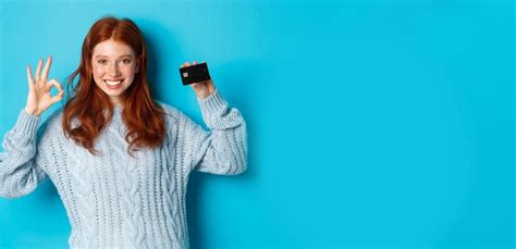 Free Photo Happy Redhead Girl In Sweater Showing Credit Card And Okay