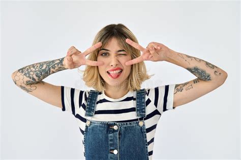 Happy Gen Z Blonde Girl Showing Tongue Peace Signs Isolated On White