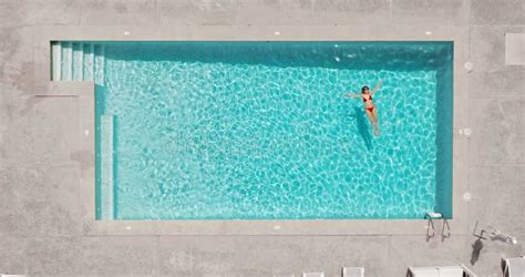Top Down View Of A Woman In Redre Swimsuit Lying On Her Back In The Pool Stock Footage Video