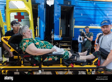 A Disabled Woman On A Portable Disabled Bed Seen On The Train Platform