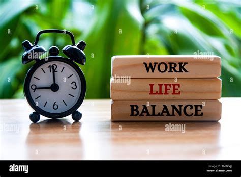 Alarm Clock Pointing At 9am With Work Life Balance Text On Wooden