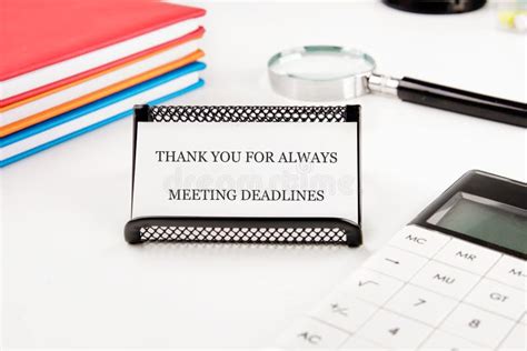 A Small Black Card Displays A Message Of Gratitude For Consistent Adherence To Deadlines On A