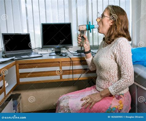 Mature Woman Performing Pulmonary Function Test And Spirometry Stock