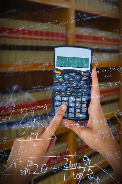 Composite Image Of Hands Of Businesswoman Using Calculator Stock Photo