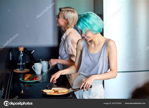 Happy Caucasian Lesbian Couple Preparing Breakfast In The Kitchen