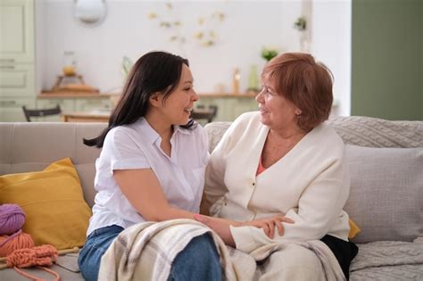 Premium Photo Affectionate Loving Middle Aged Mother Cuddling Grownup