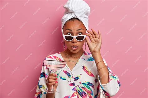 Free Photo Surprised Dark Skinned Lovely Woman Keeps Hand On