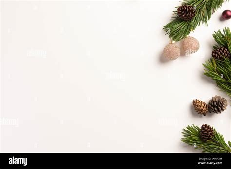 Minimal Christmas Concept Spruce Branches With Cones On A White Background Flat Lay Top View
