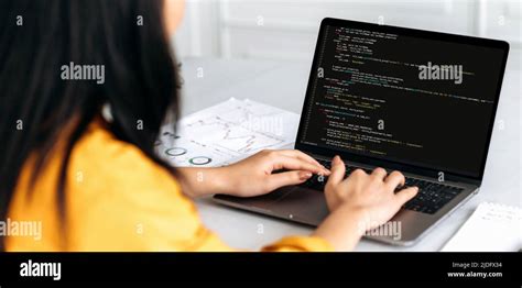Panoramic Over Shoulder View Female IT Specialist To A Laptop With