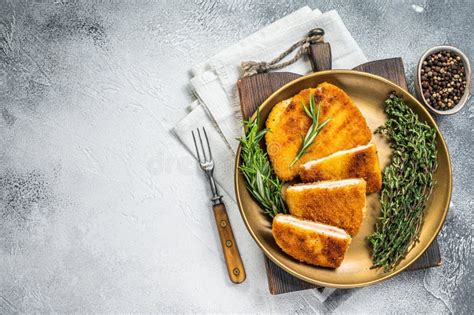 Chicken Fried Cordon Bleu Cutlet With Ham And Cheese On A Plate With