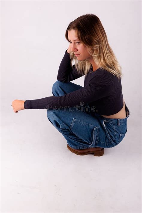 Blond Casual Girl Crouch Jeans Stock Image Image Of Jeans Hand