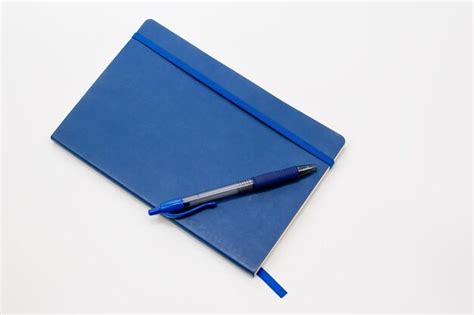 Premium Photo Blue Pen And Notepad On A White Background Notebook
