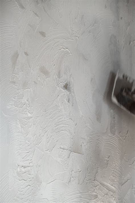 Applying Decorative Putty White Abstract Texture Of Surface Covered
