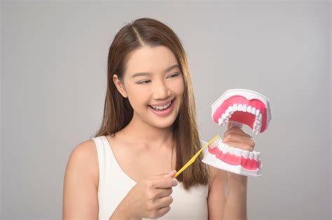 Premium Photo Young Smiling Woman Holding Toothbrush Over White