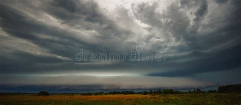 Supercell Cloud With Distant Lightning Illuminating The Storm Structure