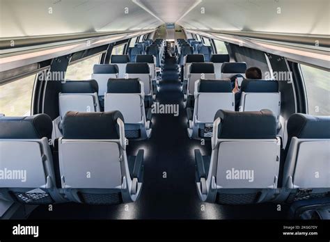 High Angle View Of Passenger Using Mobile Phone Rows Of Seats In