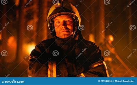 Portrait Of A Brave Handsome Young Adult Firefighter In Safety Uniform And A Helmet Posing For