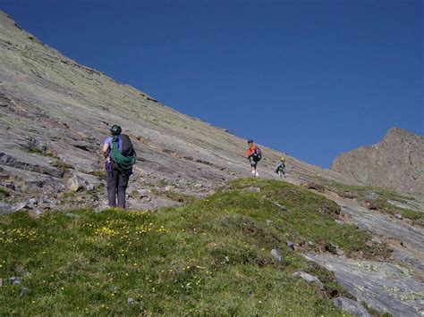 Hiking Across The Face On The Highest Grassy Ledge