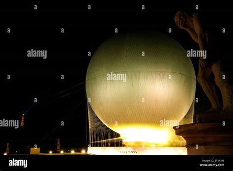 The Cauldron Is Lit Up By The Olympic Flame With The Eiffel Tower In