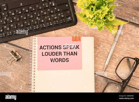 Actions Speak Louder Than Words Message On The Card Shown By A Man