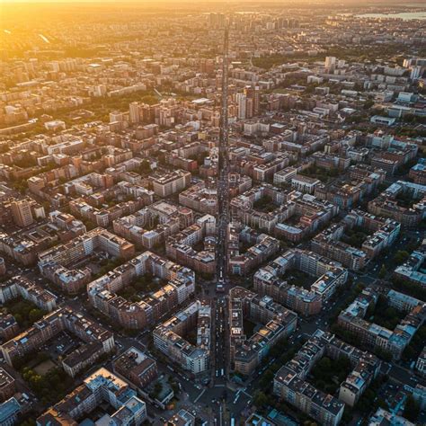 Aerial View Of A Sprawling Urban Landscape Bathed In Golden Sunlight