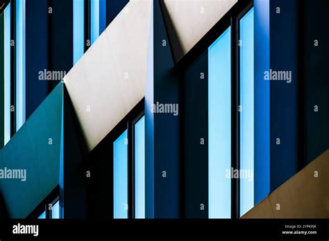 Abstract Close Up Of Modern Building Facade With Angular Patterns And Reflective Blue Windows
