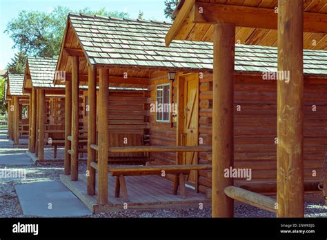Log Cabins In A Row Have Cement Walks Porches Swings They Are