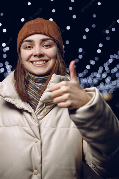 Premium Photo Woman Showing Thumb Up Or Like Gesture And Looking At