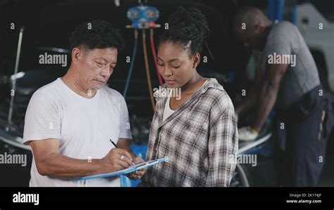 Garage Businessman Talking Explain To Car Owner About Check List Service Price Detail With