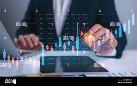Businessman Analyzing Candlestick Chart And Stock Market Graph On