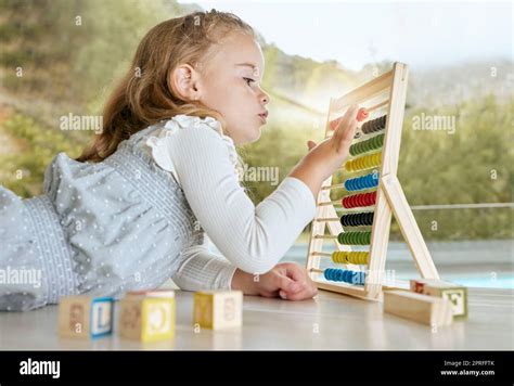 Education Abacus And Girl Learning Math With A Color Tool While Counting On The Floor Young