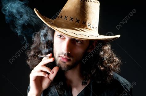 Man In Cowbow Hat Smoking Photo Background And Picture For Free
