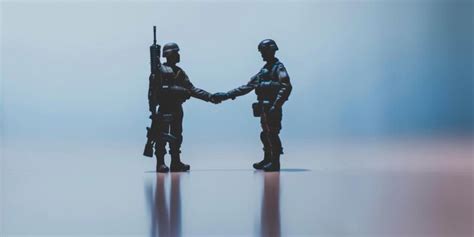 Two Soldiers Shaking Hands Scene Is One Of Peace And Cooperation The