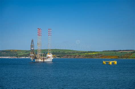 Industrial Ship Offshore Wind Turbine At The Sea Next To Yellow