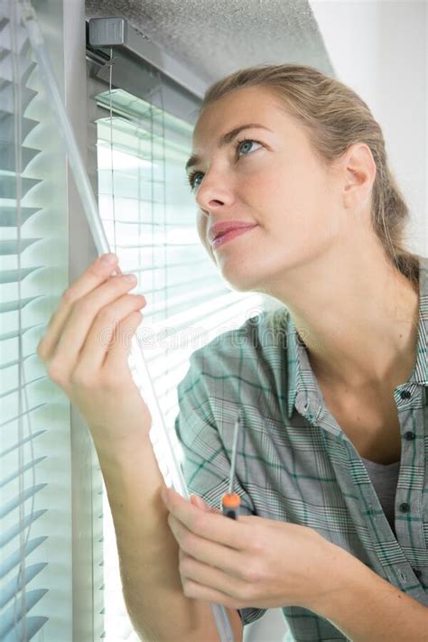 Woman With Screwdriver Adjusting Window Blind Stock Photo Image Of