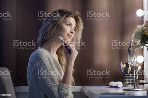 Amazing Young Woman Doing Her Makeup In Front Of Mirror Portrait Of