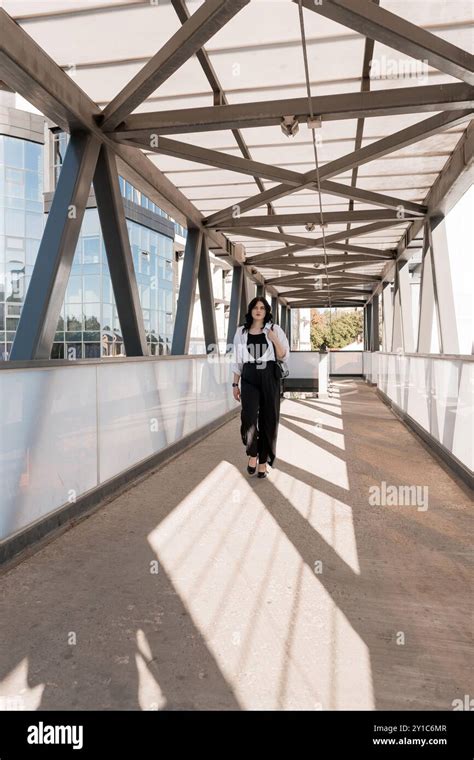 Urban Elegance Confident Woman Strolling Through Modern Architectural